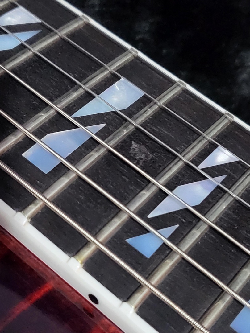 High E string gets caught under frets, any suggestions for at-home ...